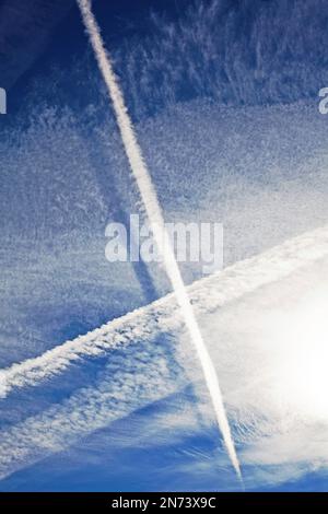 Contrails with shadow in front of the ice clouds in the sky Stock Photo ...
