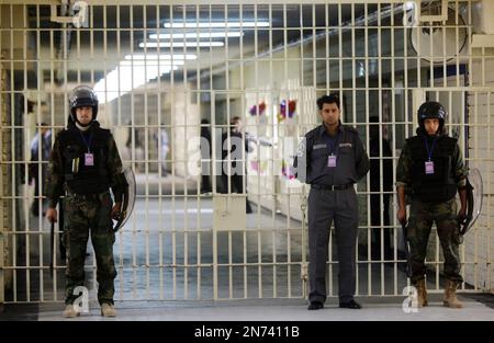 Guards stand at a cell block at the renovated Abu Ghraib prison, now ...