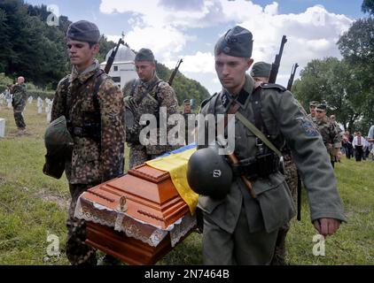 Ukrainians dressed in the SS Galychyna Division uniform march past ...