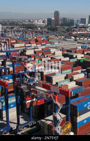 Stacked shipping containers wait to move by Automated Staking Cranes ...