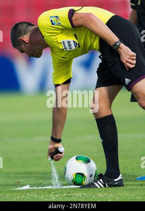 A referee marks the ball position with vanishing spray before a free ...