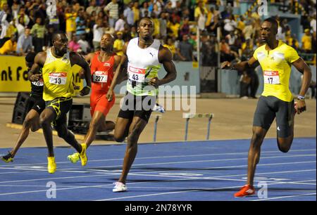 Jamaica's Asafa Powell, left, and Usain Bolt, right, celebrate after winning the men's 4x100 ...