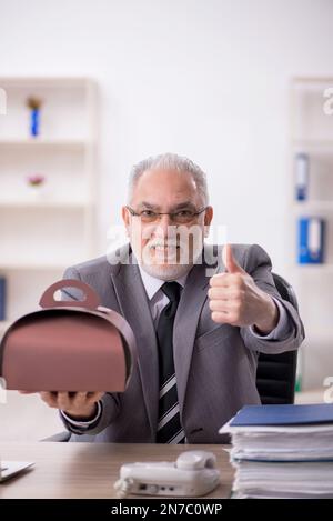 Excited businessman eating birthday cake at his desk Stock Photo - Alamy