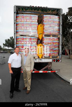 Scott Hill, Camp Pendleton Commissary Director, center, distributes a ...