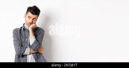 Gloomy thoughtful man looking aside, thinking or space out, staring at ...