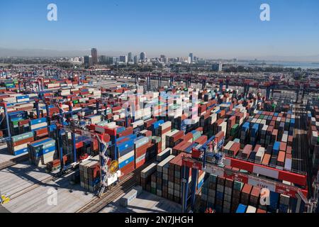 Stacked shipping containers wait to move by Automated Staking Cranes ...