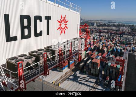 Stacked shipping containers wait to move by Automated Staking Cranes ...