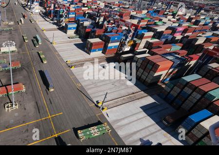 Stacked shipping containers wait to move by Automated Staking Cranes ...