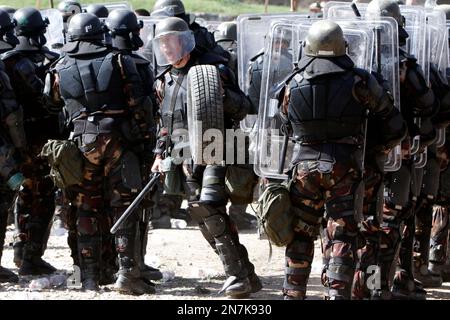 British army soldiers in riot gear with shields backlit silhouette ...