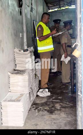 Sri Lankan police inspect a burnt-out bus outside the Sri Lankan ...