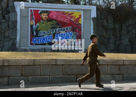 Propaganda poster depicting North Korean citizens iun front of the ...
