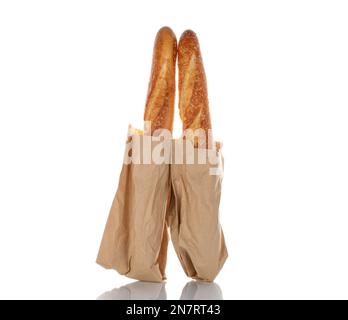 Two aromatic baguettes in a paper bag, macro isolated on white ...
