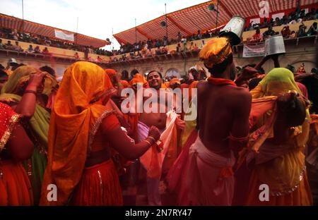 Indian Hindu women playfully tear apart clothes of a man during ...