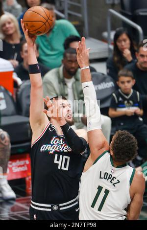 Milwaukee Bucks center Brook Lopez, right, goes up for a shot against ...