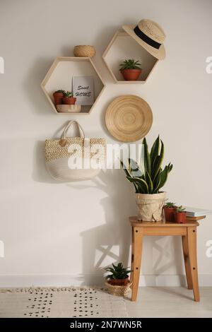 Shelving unit with wooden table and hanging lamp in modern room Stock ...