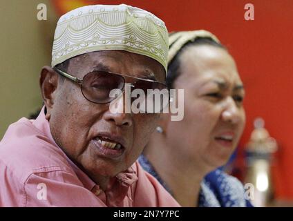 Filipino Sultan of Sulu Jamalul Kiram III, left, listens to a supporter ...