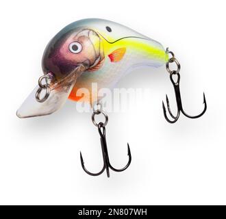 Artificial bait for fishing with a shadow behind and a pair of treble ...