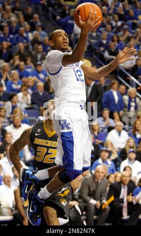 Kentucky's Ryan Harrow (12) shoots between Portland's Ryan Nicholas (32 ...