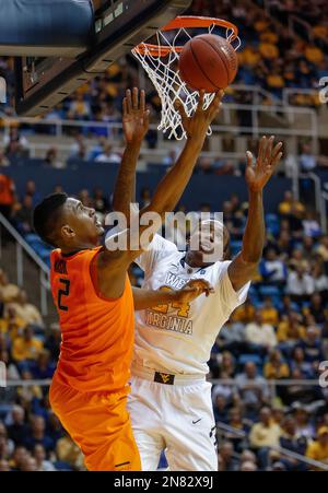 West Virginia's Aaric Murray (24) is defended by Radford's Kion Brown ...