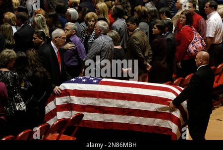 Family, friends and neighbors came to pay their respects at a makeshift ...