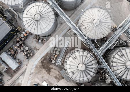 A row of large scale, industrial storage tanks or silos at a chemical ...