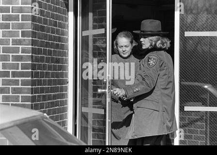 Jean Harris, handcuffed and carrying a book, leaves the Westchester ...
