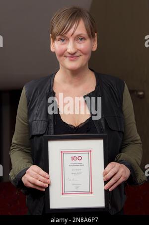 Miriam Buether holds her Best Designer Award for Wild Swans, following ...