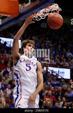 Kansas center Jeff Withey (5) dunks during the first half of an NCAA ...