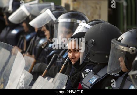 Female Pakistani riot police guard a barricade outside the residence of ...