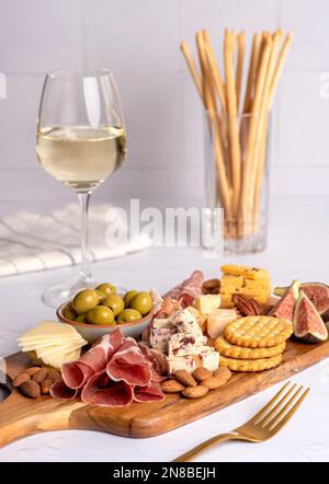 Food photography of wine, salami, grissini, cheese, figs, crackers ...