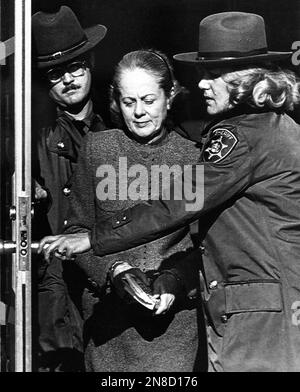 Jean Harris, handcuffed and carrying a book, leaves the Westchester ...