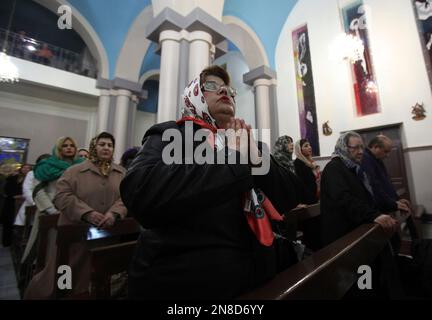Iranian Christian worshippers pray during Christmas mass at the Saint ...