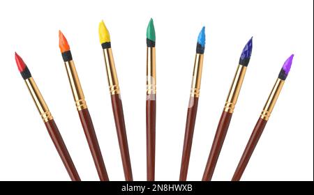 Collage of brushes with different bright paints on white background ...