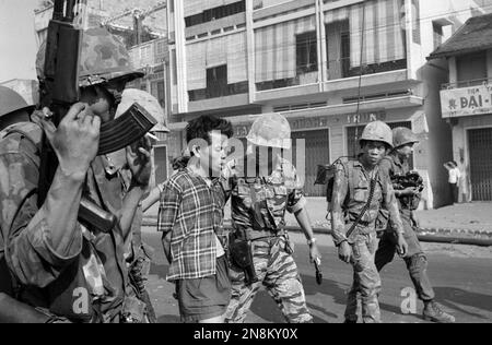 South Vietnamese forces escort suspected Viet Cong officer Nguyen Van ...