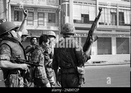 South Vietnamese forces escort suspected Viet Cong officer Nguyen Van ...