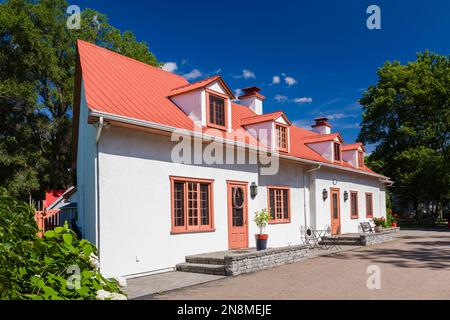 Old 1850 white stucco and peach Canadiana cottage style house facade ...