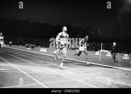 Track and field athlete John Carlos, right, poses with other athletes ...