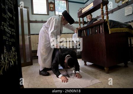 A Rabbi whips a man with leather straps as a symbolic punishment for ...