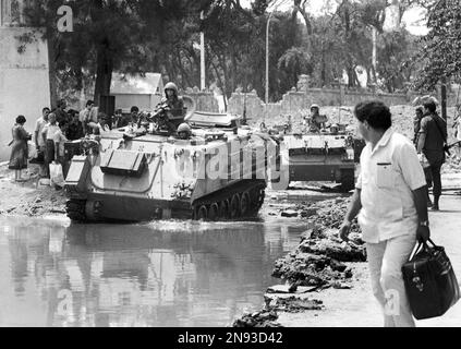 Lebanese armoured personnel carriers drive through the village of Ain ...