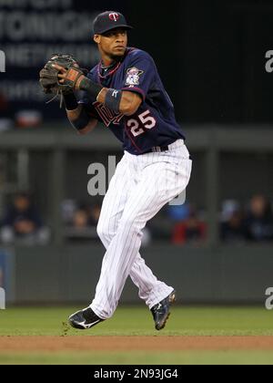 Minnesota Twins shortstop Pedro Florimon makes the throw on a ground ...