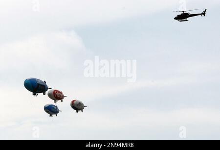 Four advertising blimps, DirecTV, Hood, Horizon, and MetLife, fly ...