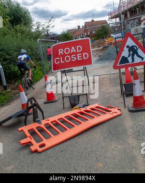 Mess of assorted road signs, traffic cones, metal fencing and a ...