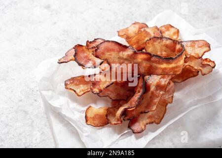 Cooked bacon rashers on parchment, closeup Stock Photo - Alamy