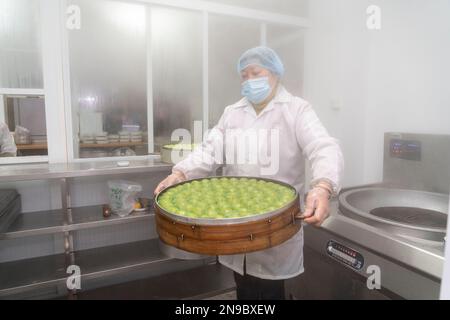 KUNSHAN, CHINA - FEBRUARY 11, 2023 - An employee of a pastry shop makes ...
