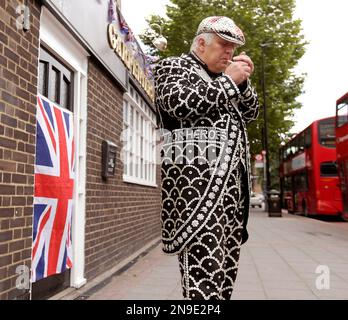 Jimmy Jukes, the Pearly King of Camberwell and Bermondsey, checking ...
