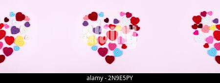 Multicolored crocheted hearts are laid out in the shape of the moon on ...