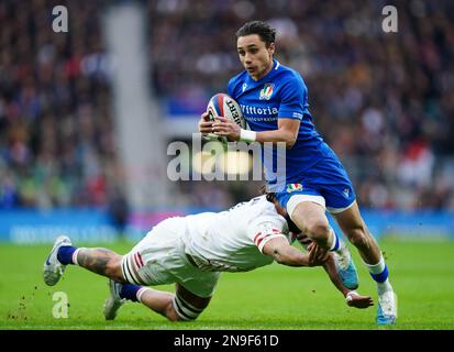 Italy's Ange Capuozzo, is tackled by England's Tom Curry, left and ...