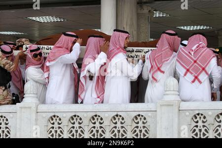 Relatives from the Saudi royal family pray during the funeral of the ...