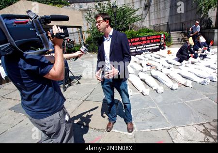 Ian Bassin, campaign director for Avaaz, speaks to the news media as ...