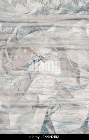cellophane on metallic crumpled blue background. plastic textures ...